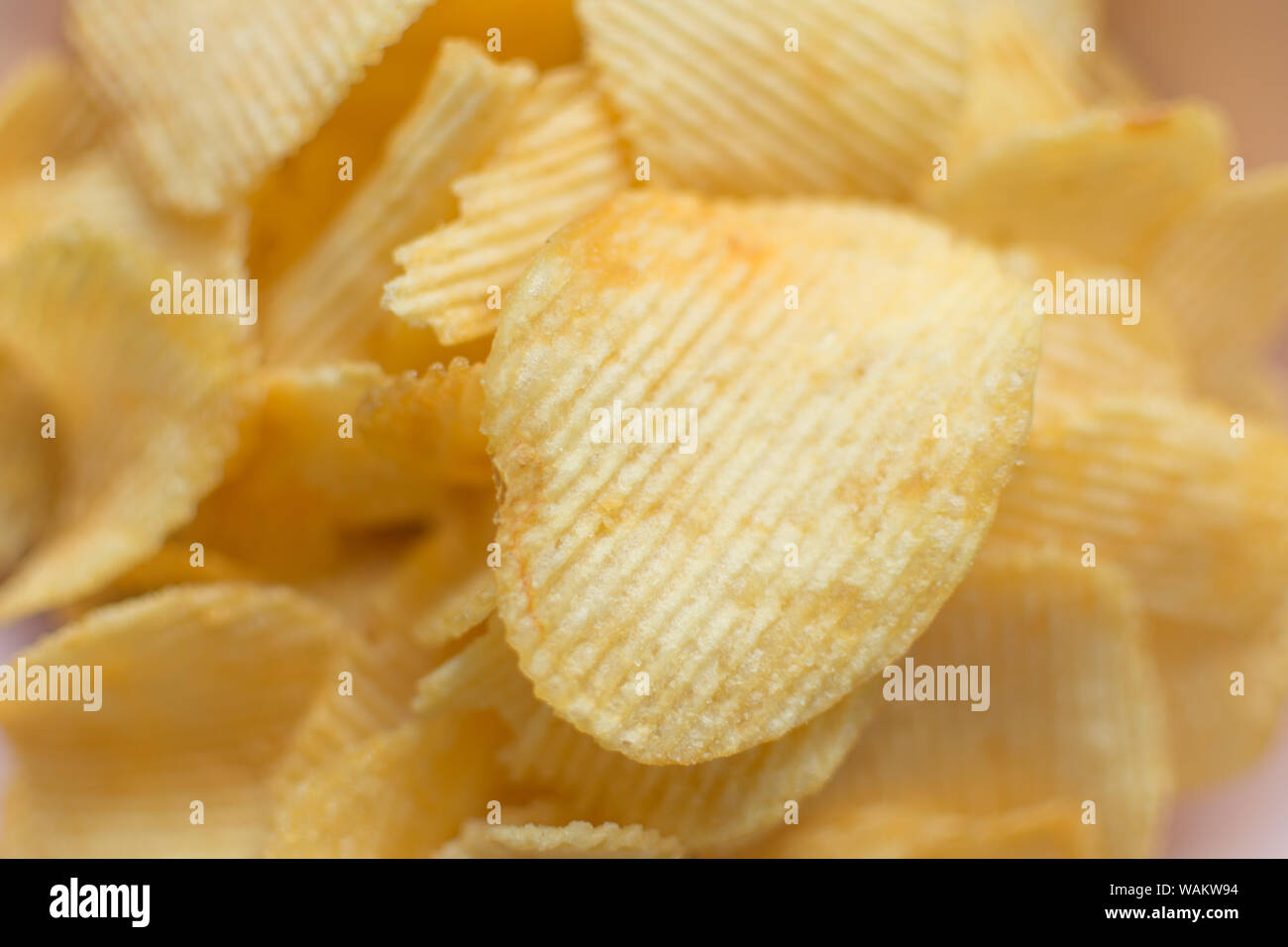 Heap of ribbed potato crisps. Potato chips, unhealthy eatting Stock ...