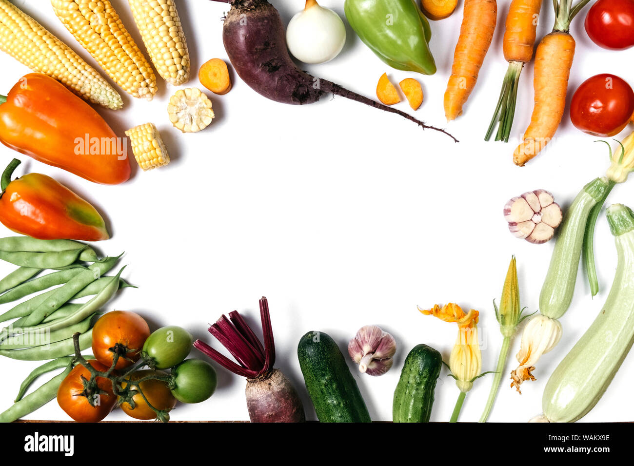 Creative layout made of autumn vegetables. Tomatoes, onion, cucumber ...