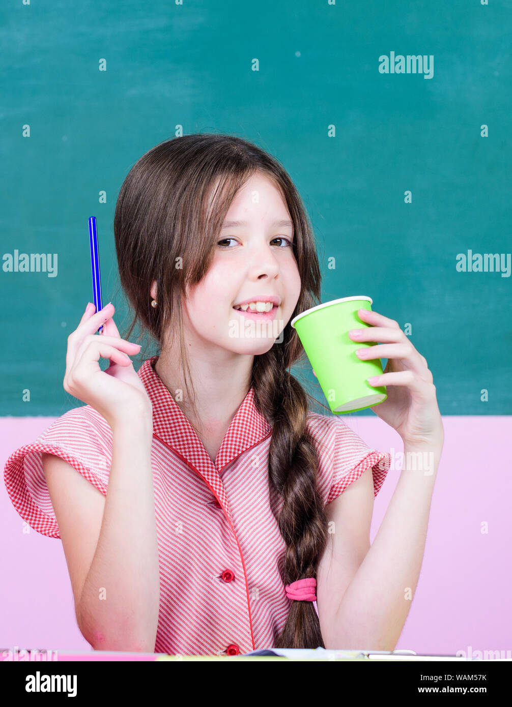 Homework is done. Inspiring drink. Girl cute child drink cocoa or tea ...