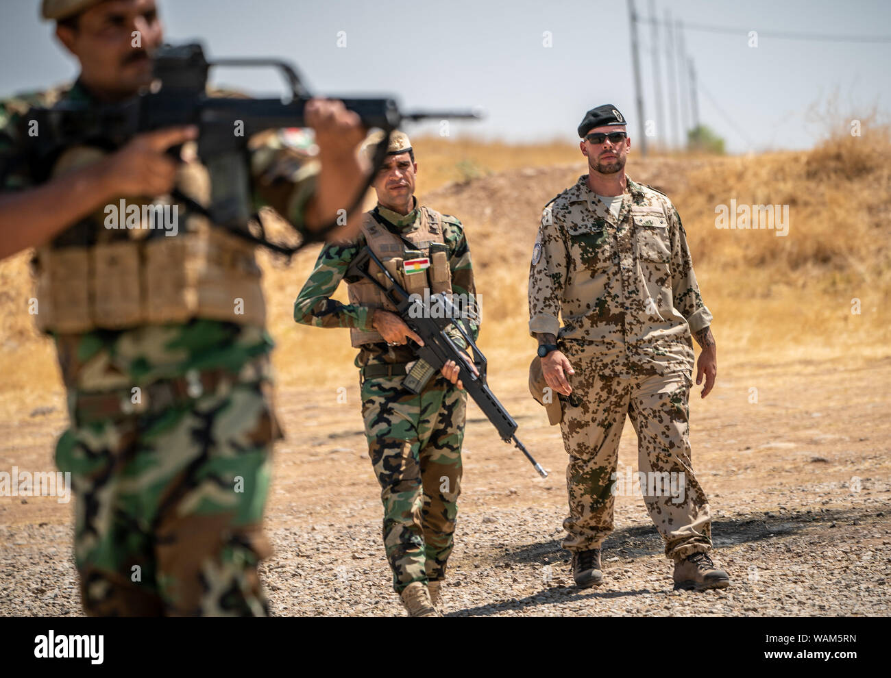 Erbil, Iraq. 21st Aug, 2019. A Bundeswehr soldier accompanies the ...