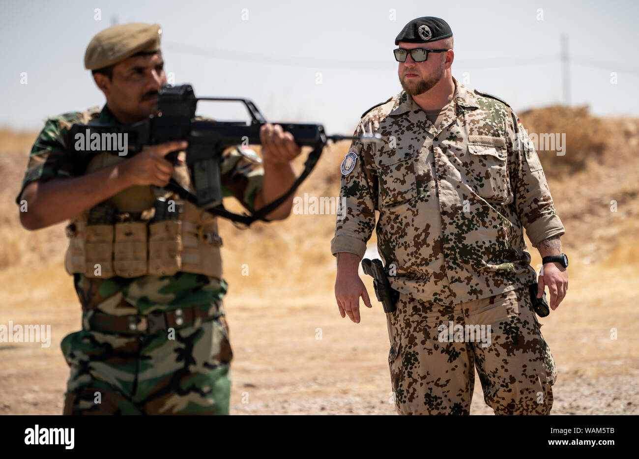 Erbil, Iraq. 21st Aug, 2019. A Bundeswehr soldier accompanies the ...
