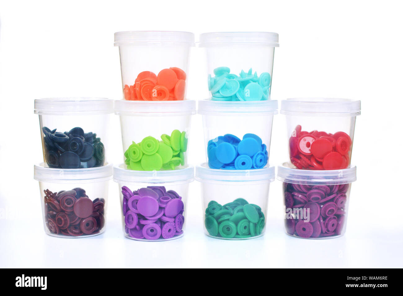 Staples of colorful plastic snap fastener buttons in transparent ...