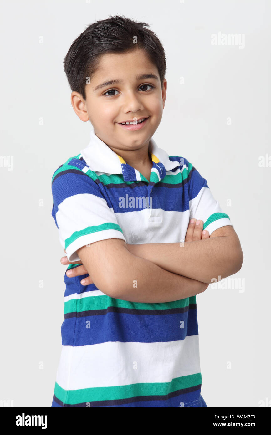 Boy smiling with his arms crossed Stock Photo - Alamy