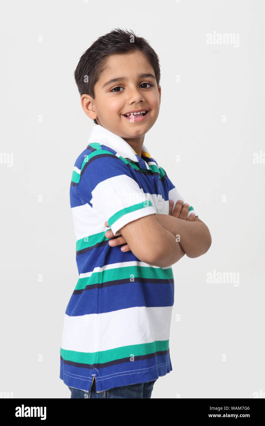 Boy smiling with her arms crossed Stock Photo - Alamy