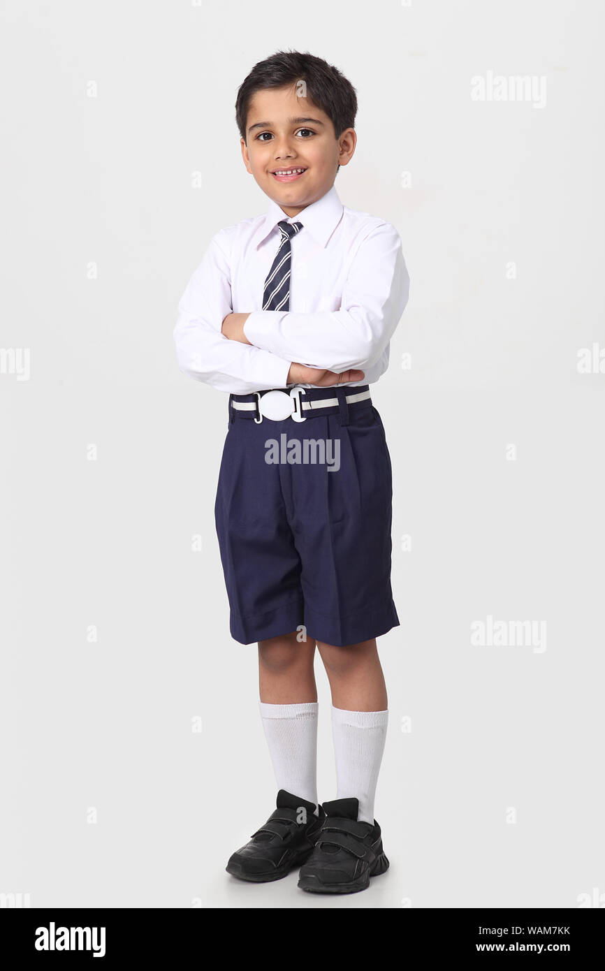 Schoolboy standing with his arms crossed Stock Photo - Alamy