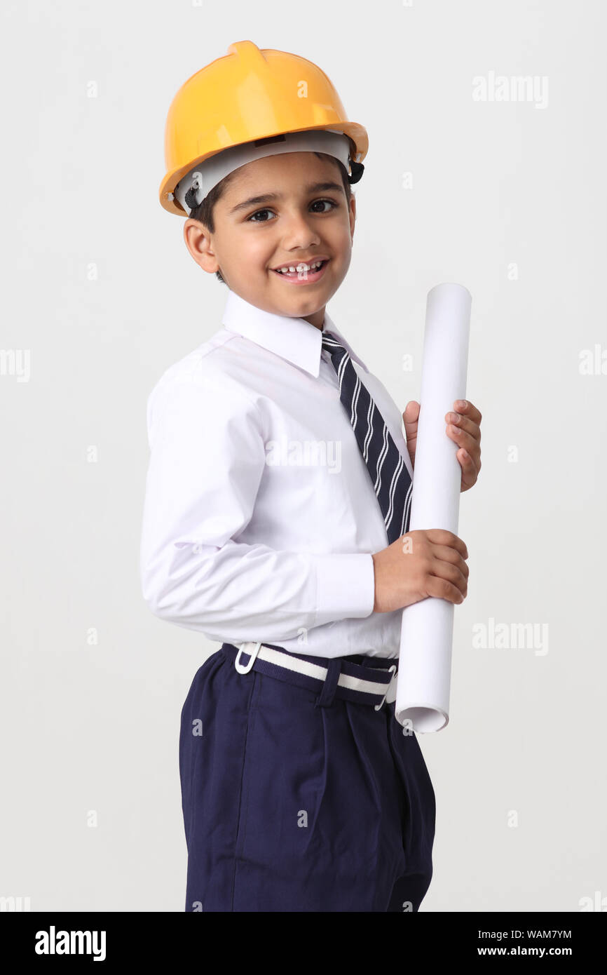 Boy pretending to be an architect and holding a blueprint Stock Photo ...