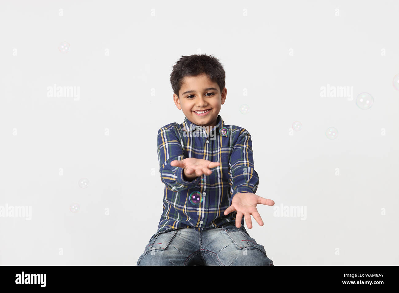 Boy catching bubbles Stock Photo - Alamy