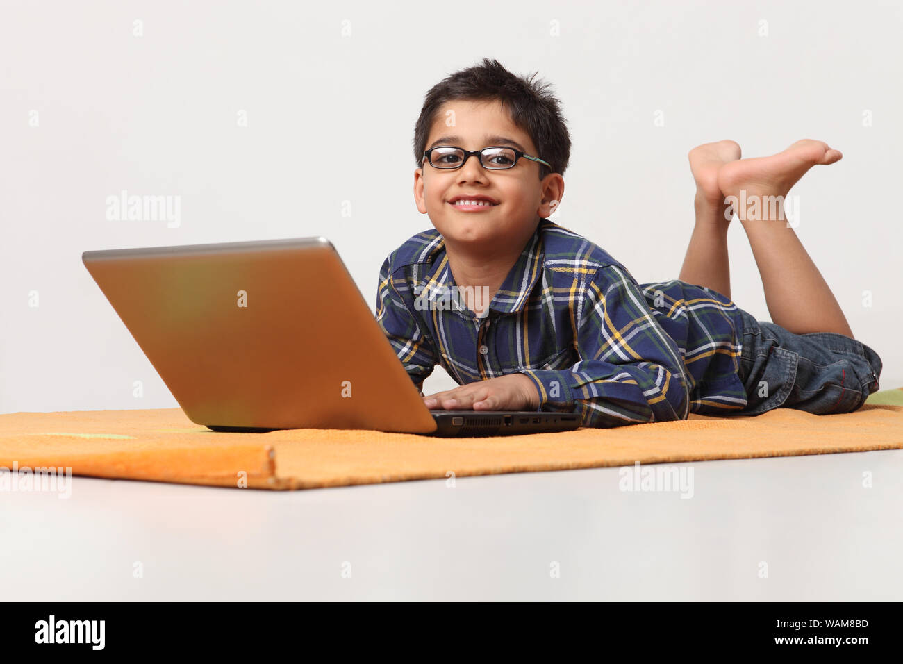 Boy using a laptop and smiling Stock Photo - Alamy