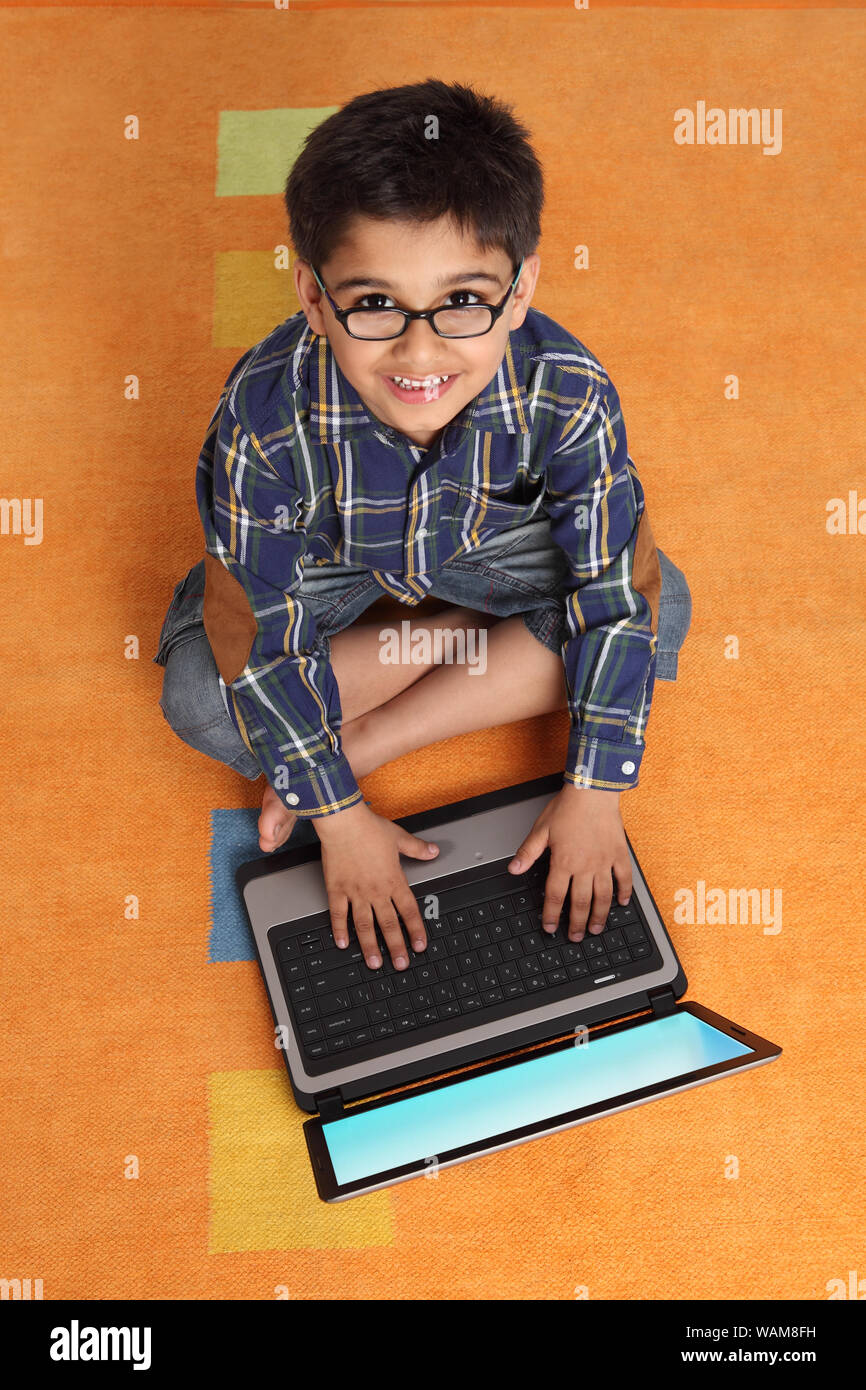 Boy looking into the laptop and working hi-res stock photography and ...