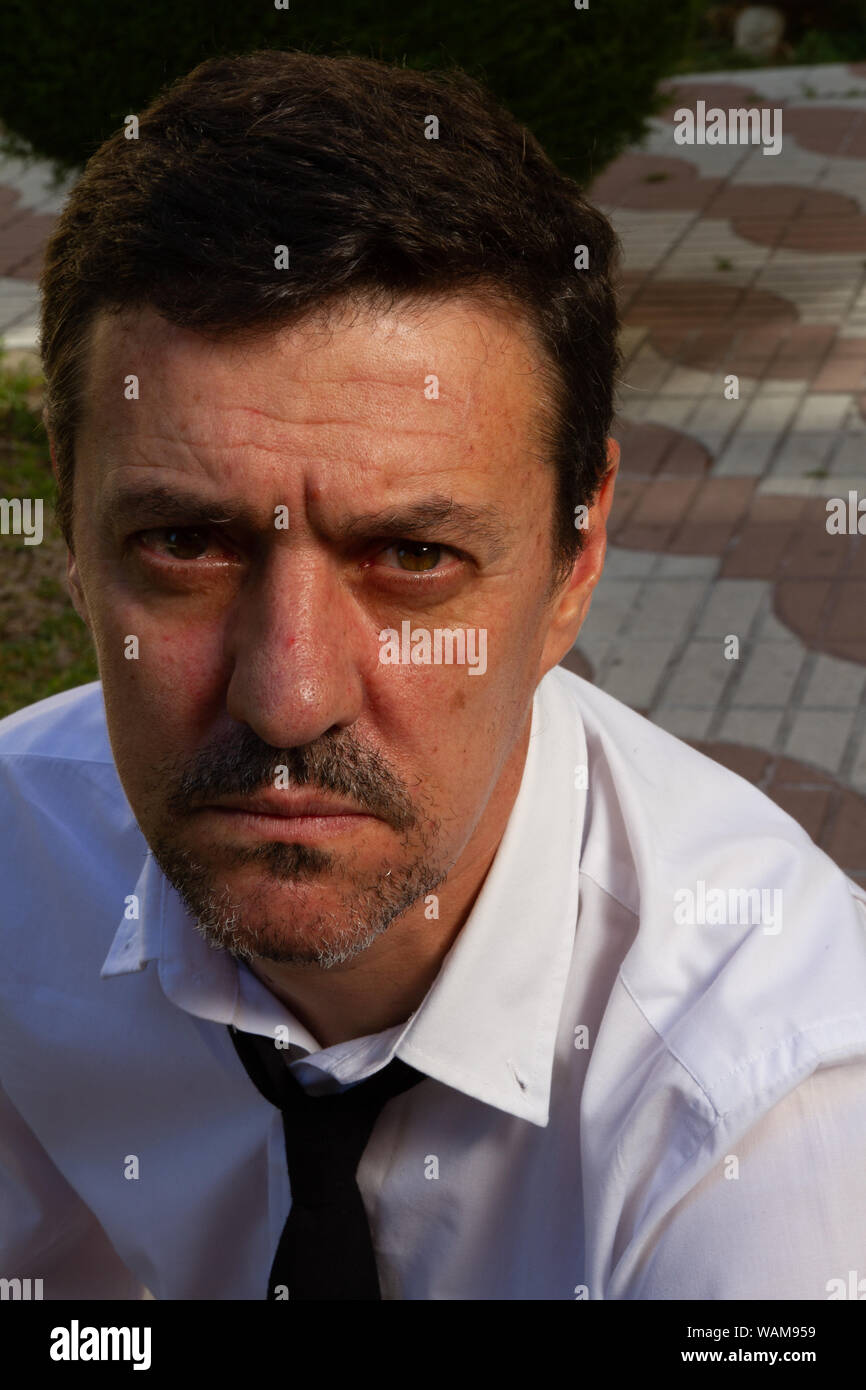 Serious man outdoor shoot with flash Stock Photo - Alamy