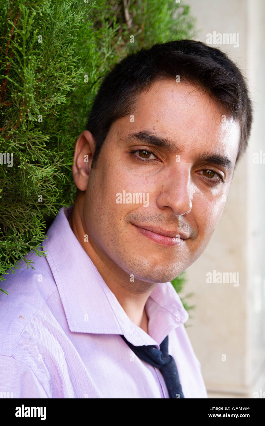 Young man, looking directly at the camera, a professional waiting Stock ...