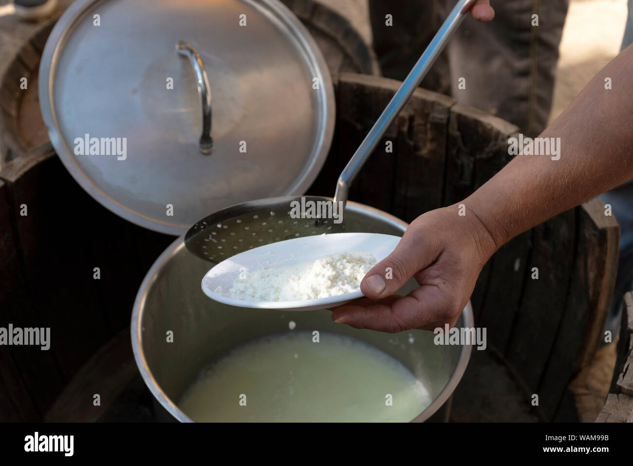 CRETE, GREECE. Production of feta cheese. The cheese is placed on a ...