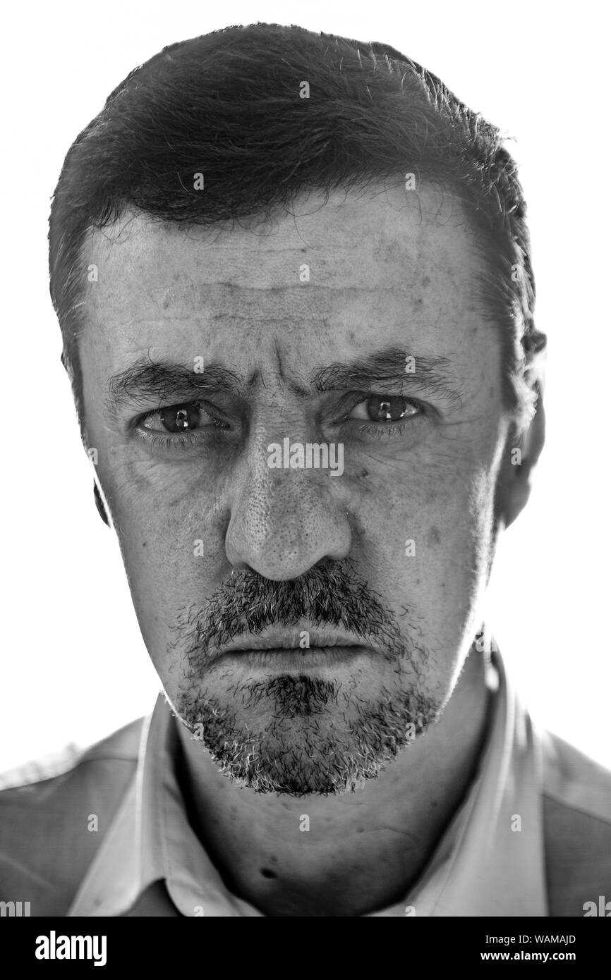 Serious man looking front with backlit Stock Photo - Alamy