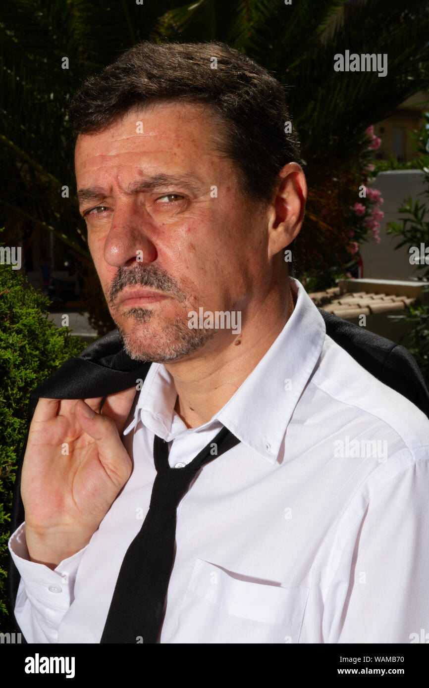 Serious man in villain-style outdoor movie with front lighting Stock ...