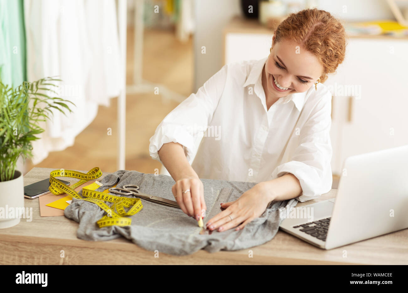 Fashion designer drawing patterns with soap on grey cloth Stock Photo ...