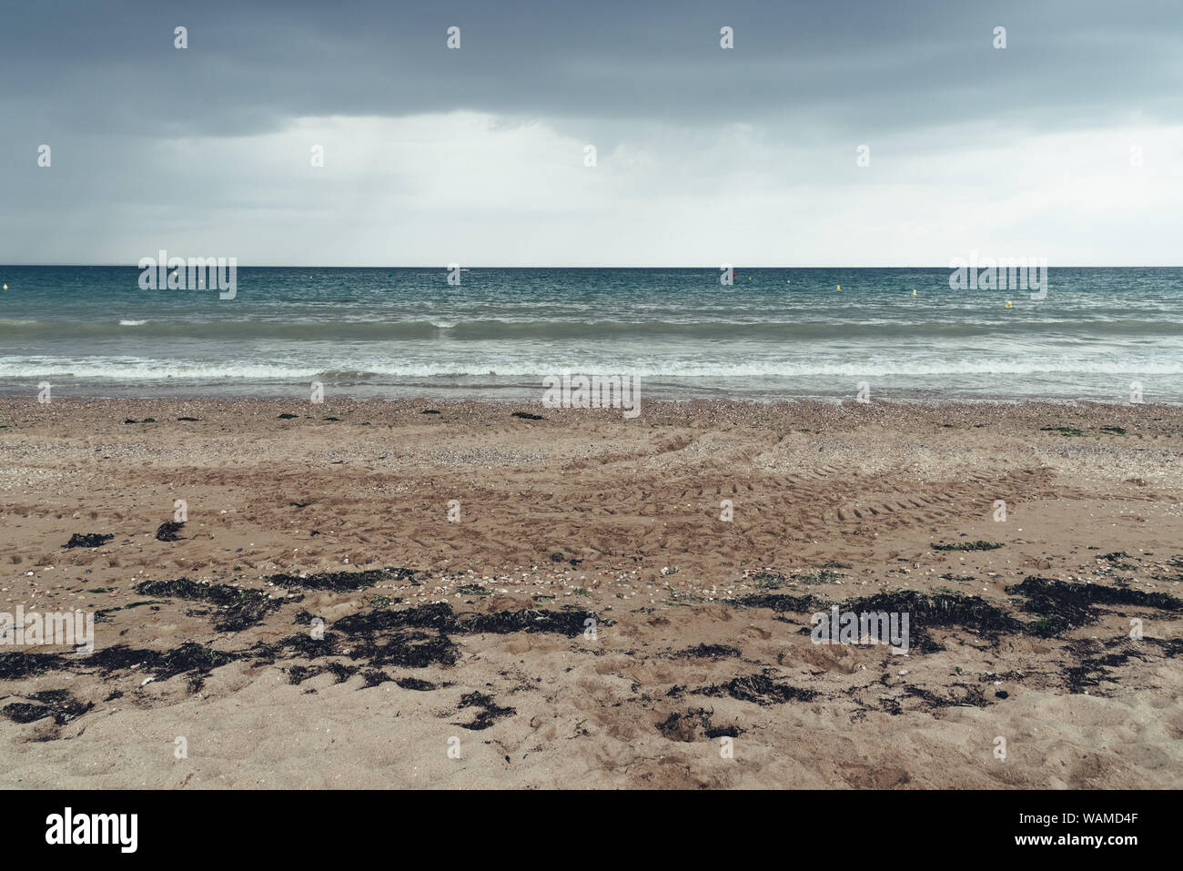 Beach with dark clouds and incoming rain storm. Vacation with bad ...