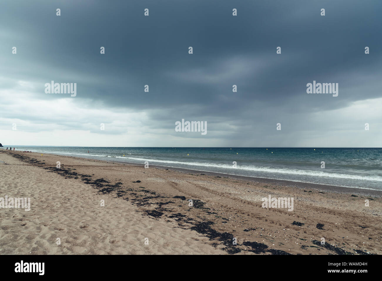 Beach with dark clouds and incoming rain storm. Vacation with bad ...