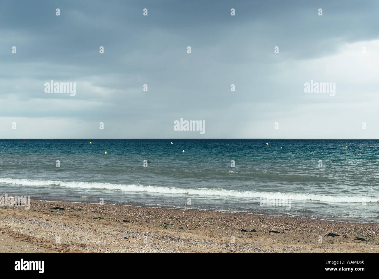 Beach with dark clouds and incoming rain storm. Vacation with bad ...