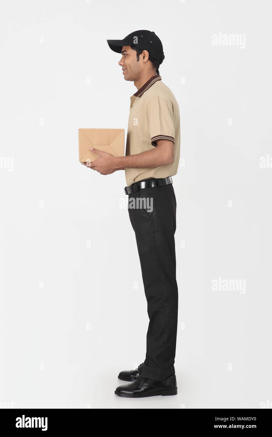 Delivery man holding parcel Stock Photo - Alamy