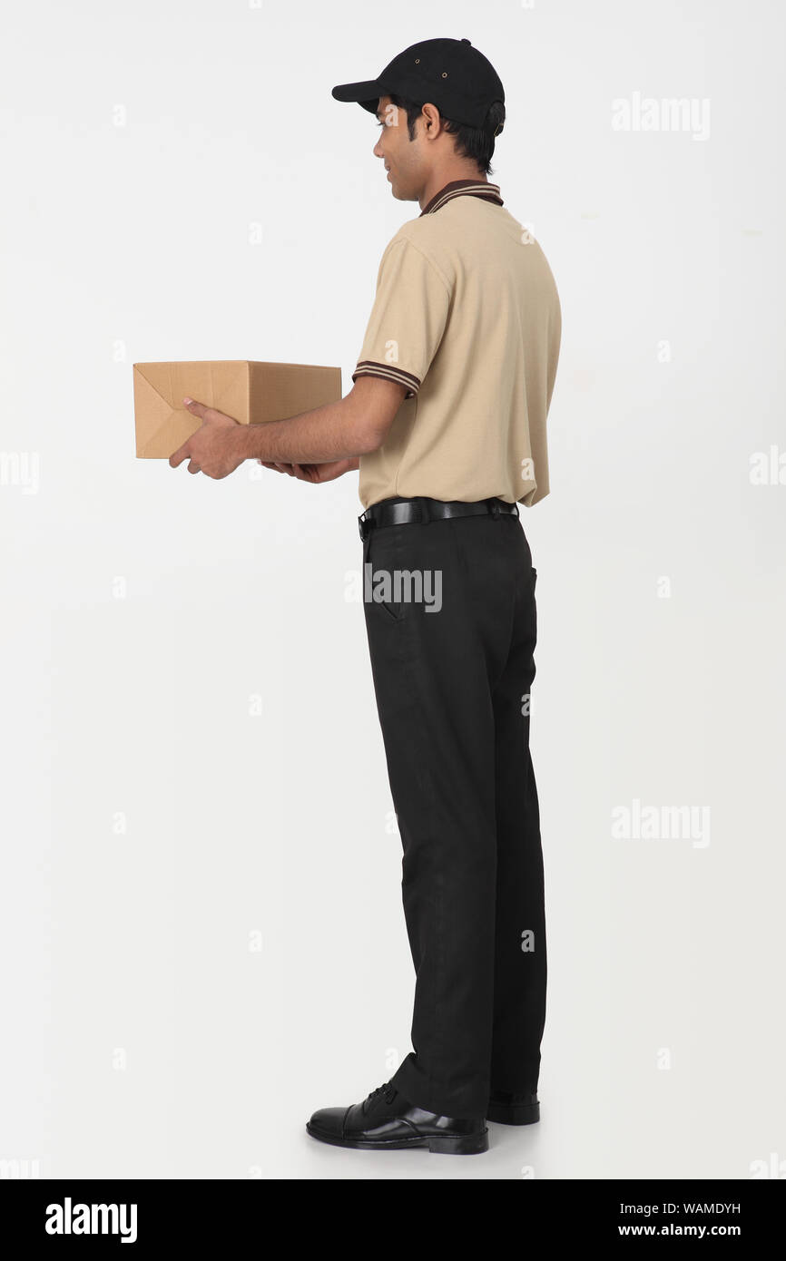 Side profile of a delivery man holding parcel Stock Photo - Alamy