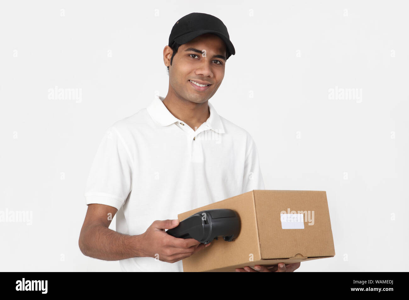 Delivery man holding parcel with card reader and smiling Stock Photo ...