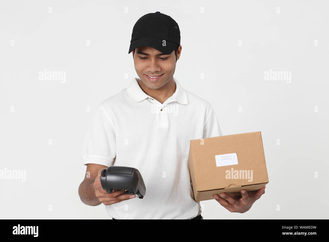 Indian delivery man holding parcel with card reader and smiling Stock ...