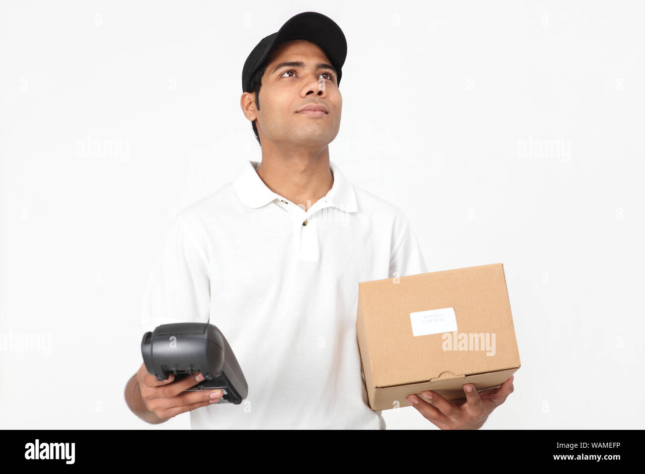 Indian delivery man holding parcel with card reader Stock Photo - Alamy