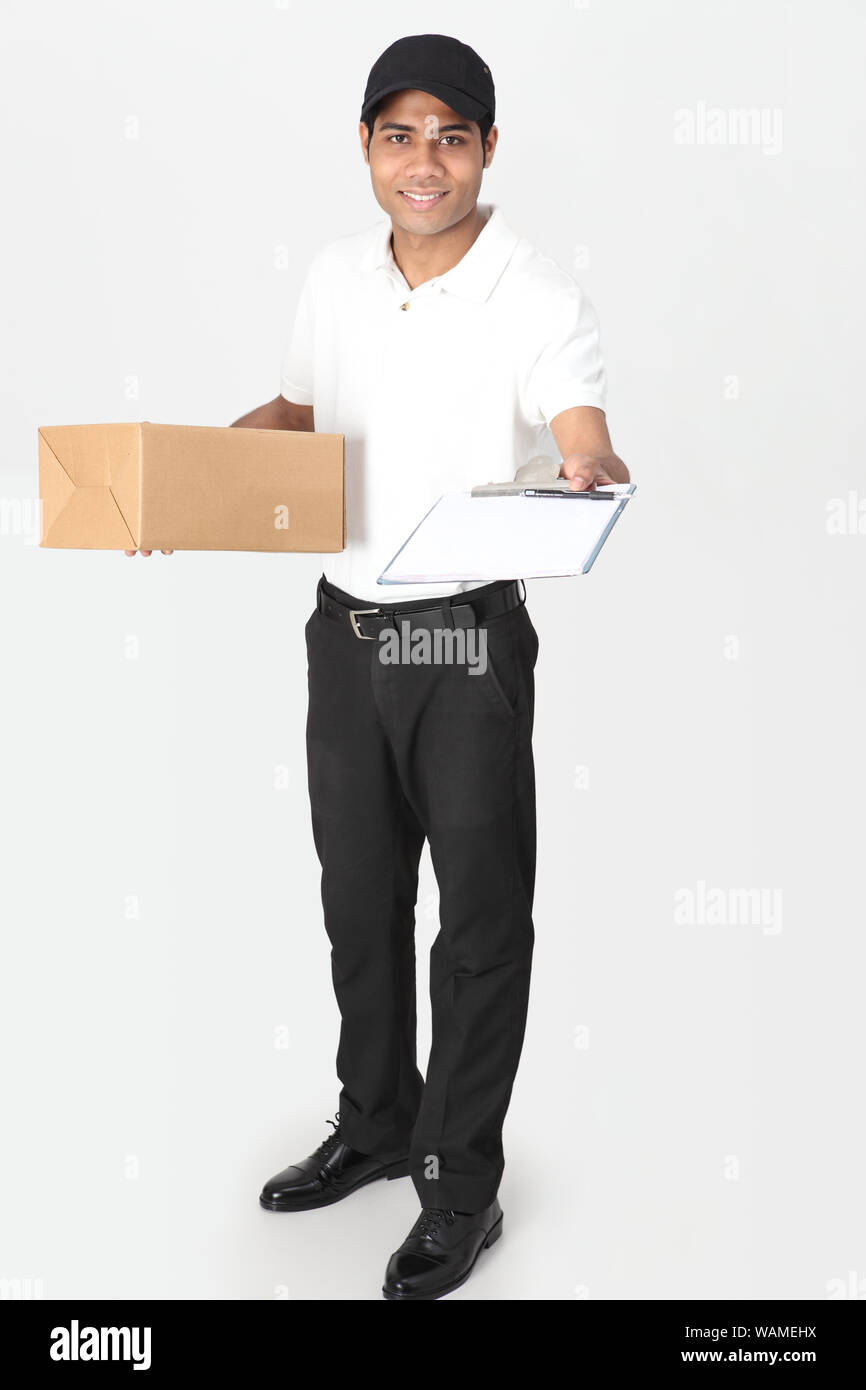 Delivery man delivering parcel Stock Photo - Alamy
