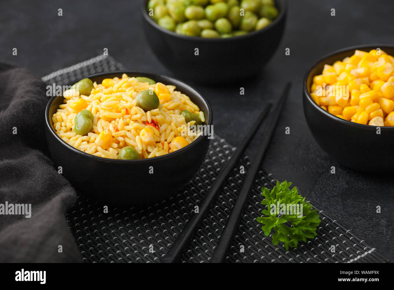 Black bowl with boiled organic basmati vegetable rice with black ...