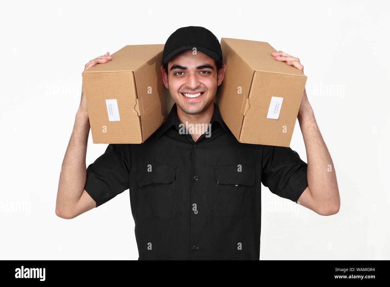 Delivery man carrying parcels on shoulder Stock Photo - Alamy