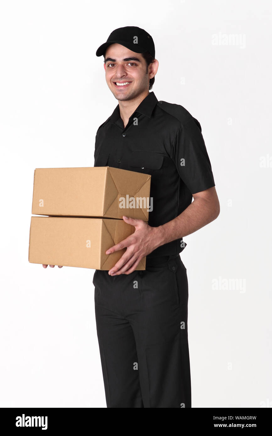 Delivery man standing with parcel Stock Photo - Alamy