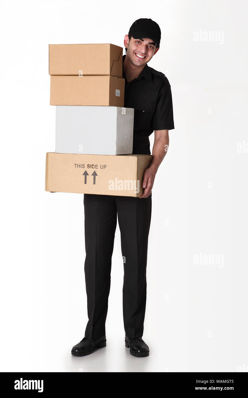 Delivery man standing with parcel Stock Photo - Alamy