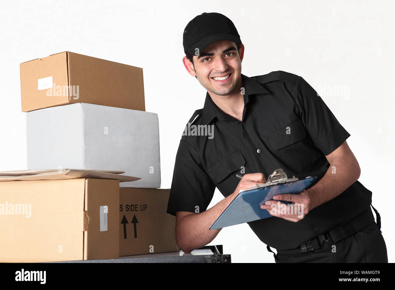 Delivery man delivering parcel Stock Photo - Alamy