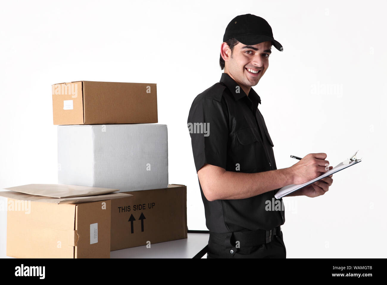 Delivery man delivering parcel Stock Photo - Alamy