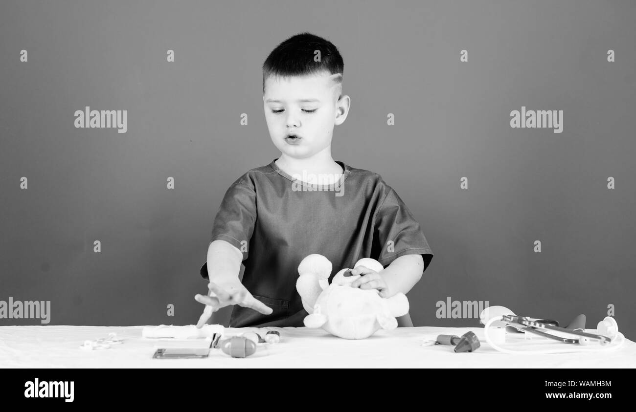 pediatrician intern. little boy in medical uniform. hospital. medicine ...