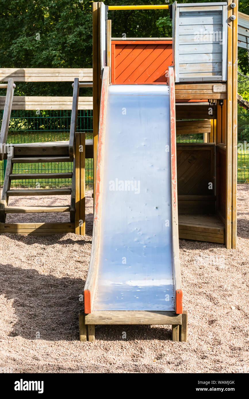 Playground slide on the sand at summer Stock Photo - Alamy