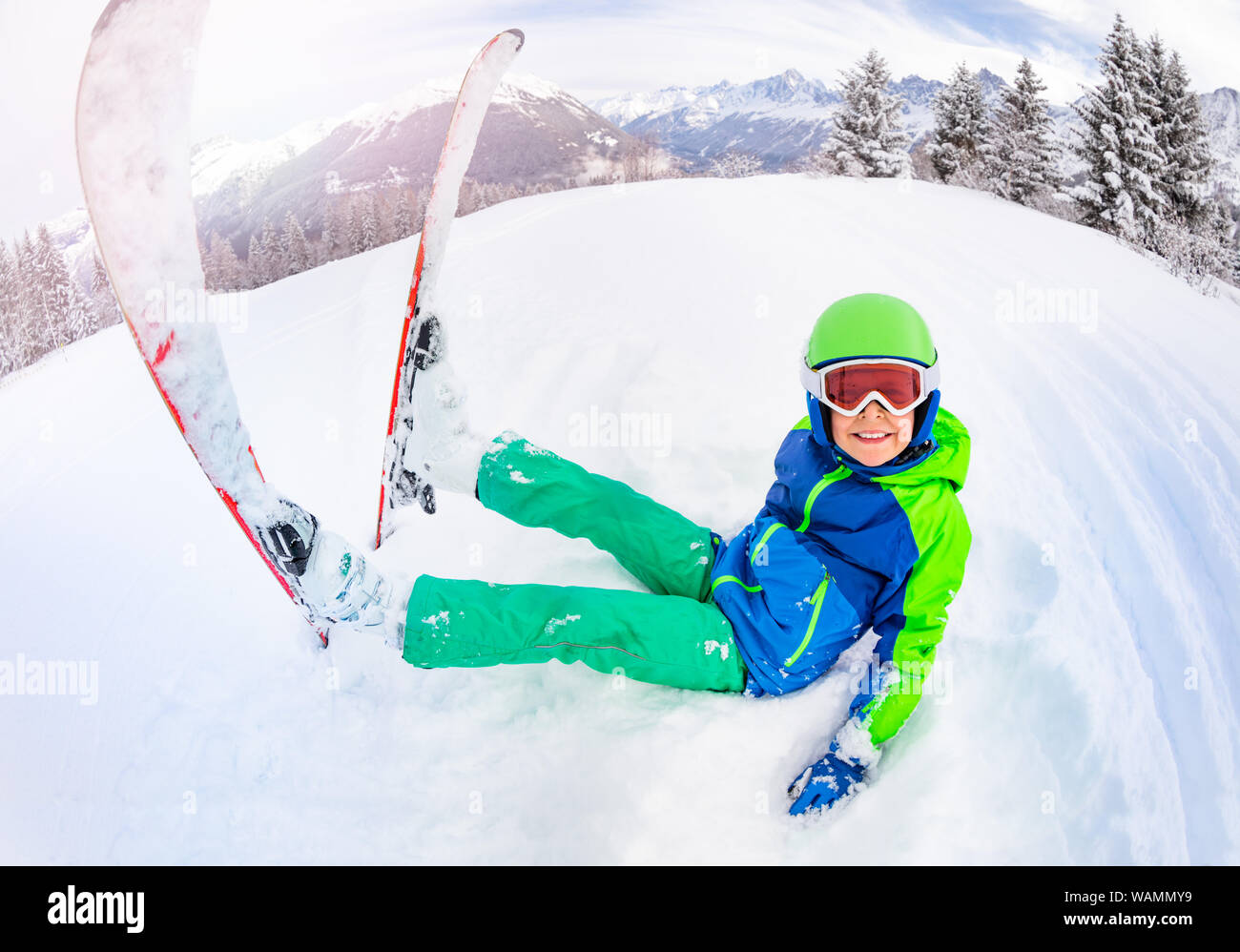 Wide angle portrait of boy with ski sit in snow Stock Photo - Alamy