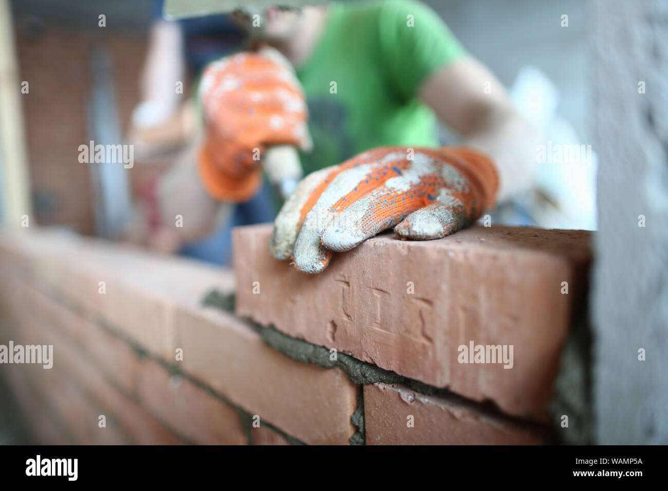 Male hands putting bricks Stock Photo - Alamy
