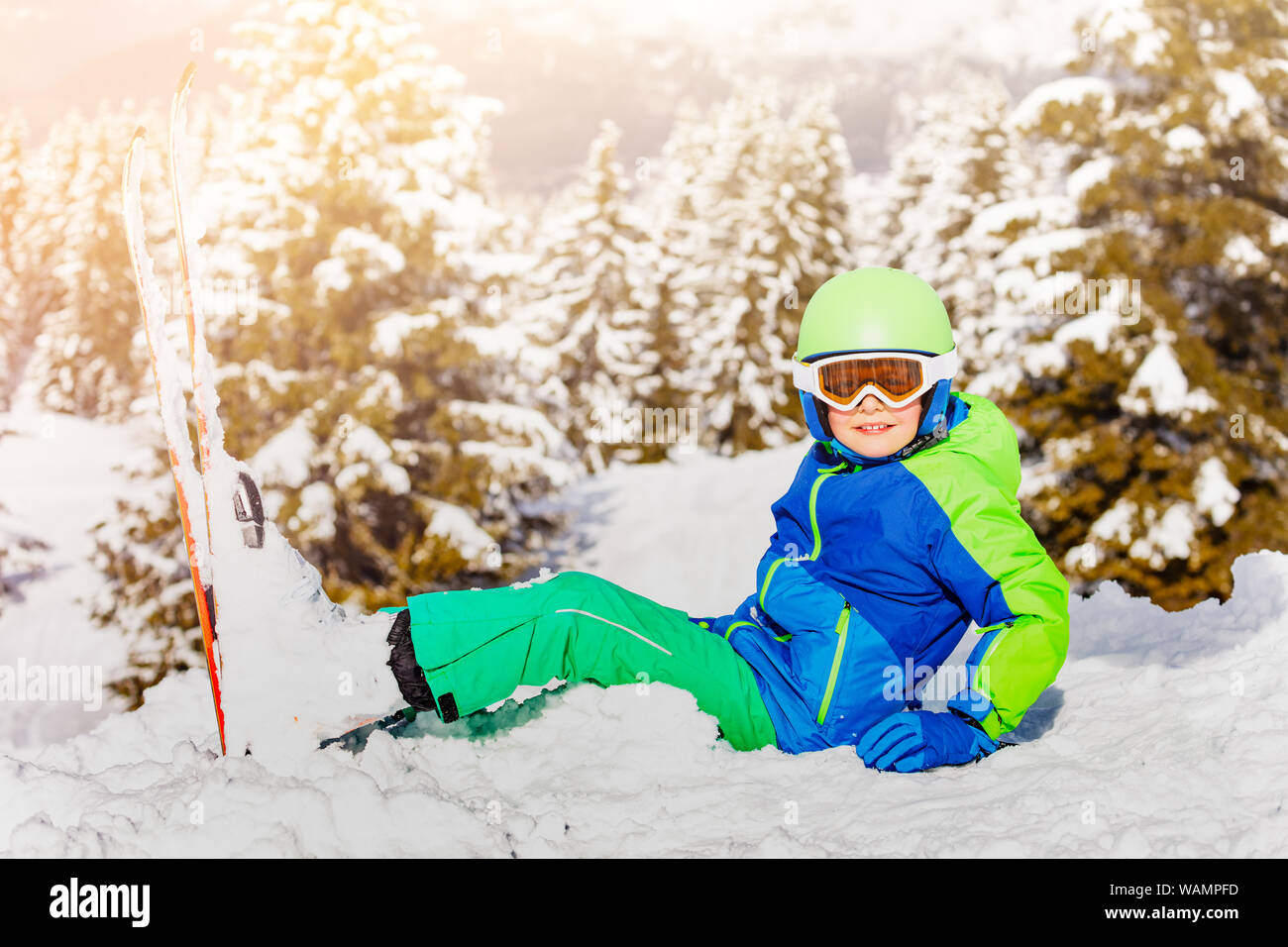 Boy in snow with ski sit over white forest trees Stock Photo - Alamy