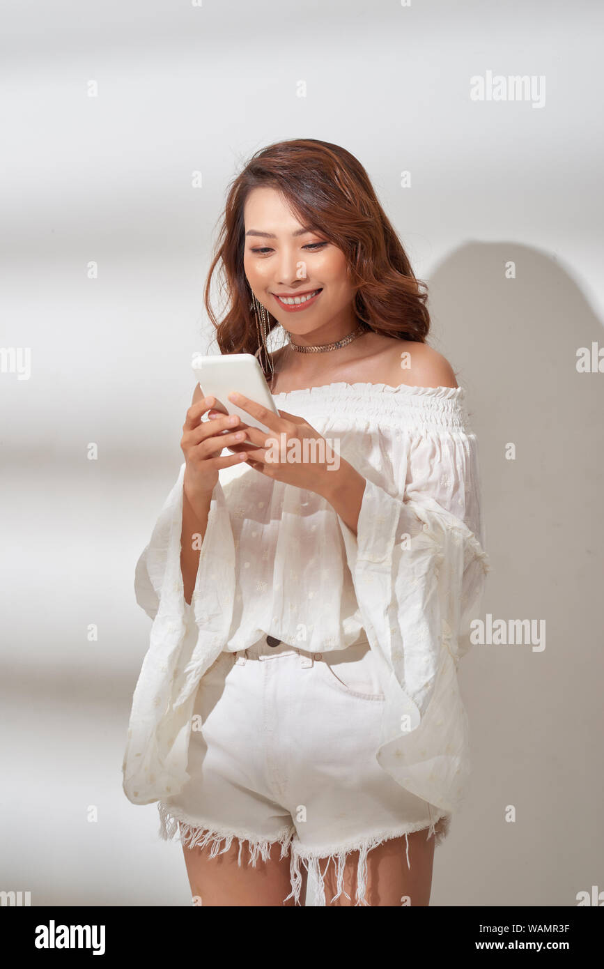 Smiling, positive asian woman with beautiful emotional face listening ...