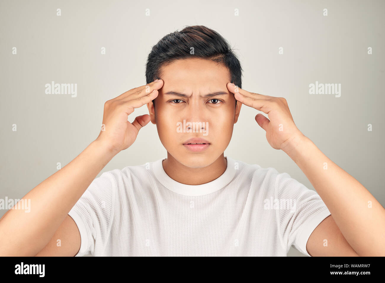 People, stress, tension and migraine concept. Upset unhappy young man ...