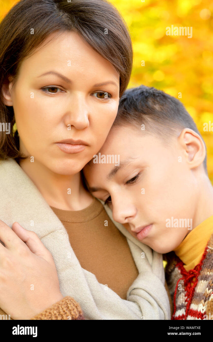 Close up portrait of sad mother with son in autumnal park Stock Photo ...