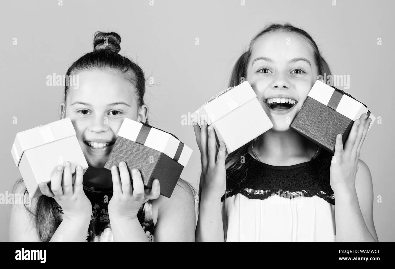 children. Little sisters with gift. Surprise. Family sisterhood ...