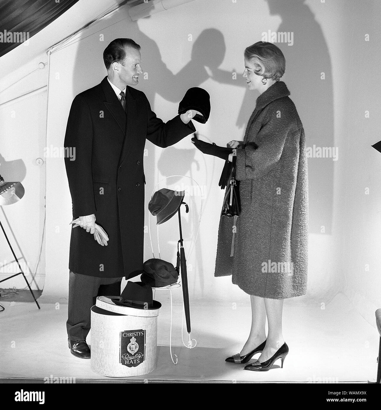 Christys' hats London. A couple is photographed in a studio wearing ...