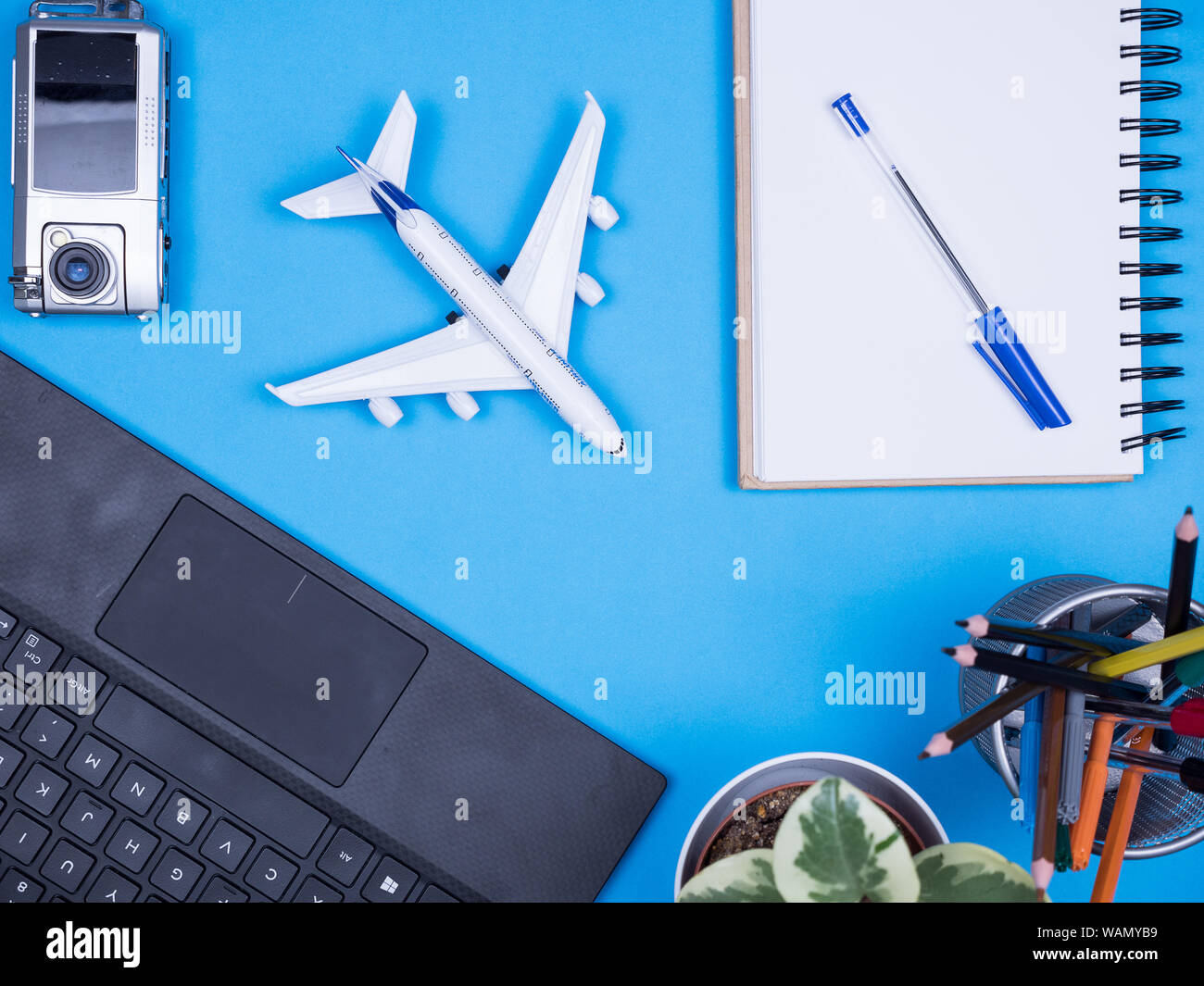 Flat lay top view of modern traveler over blue background. Modern ...