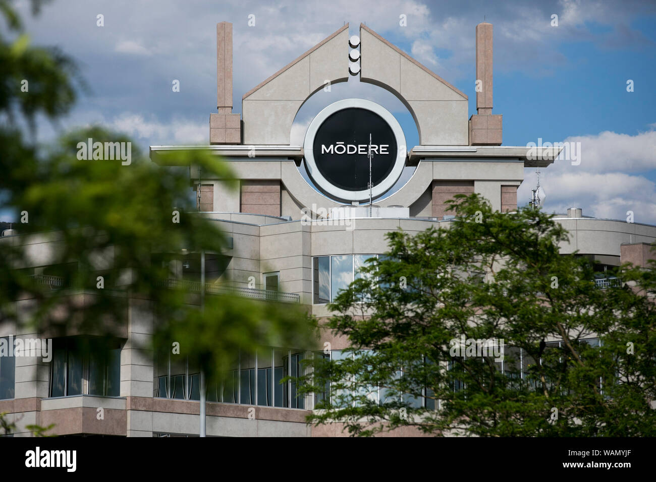 A logo sign outside of the headquarters of Modere in Springville, Utah ...