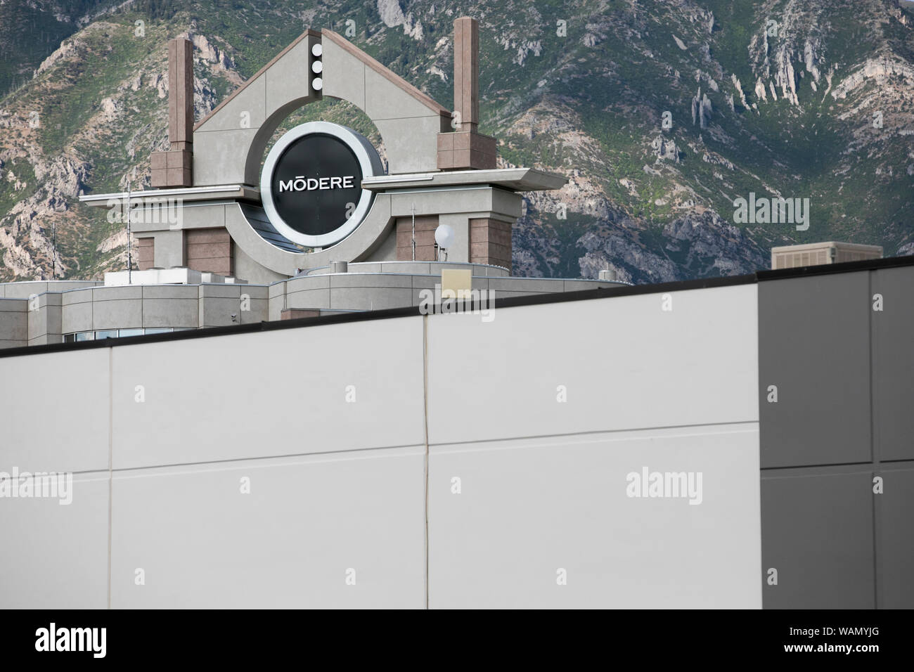 A logo sign outside of the headquarters of Modere in Springville, Utah ...