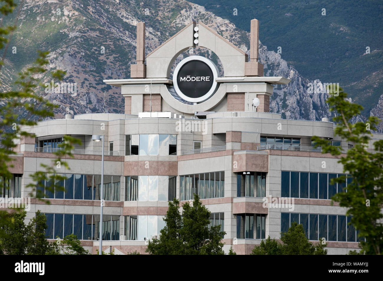 A logo sign outside of the headquarters of Modere in Springville, Utah ...