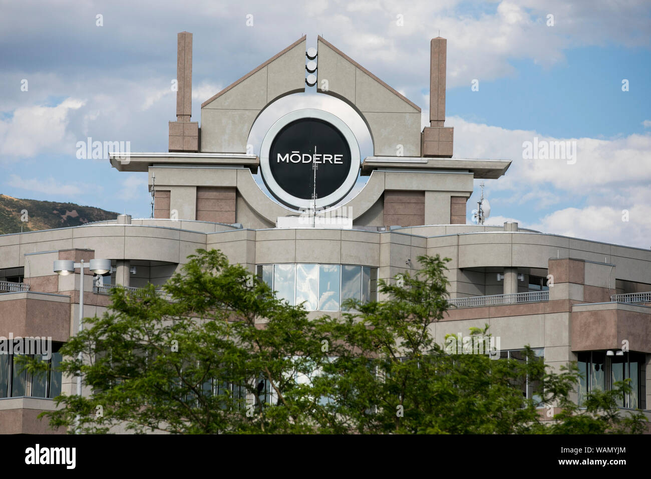 A logo sign outside of the headquarters of Modere in Springville, Utah ...