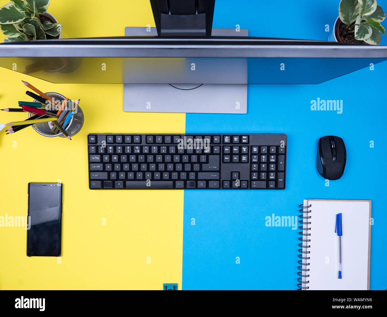 Flat lay top view of computer monitor over blue background. Freelancer ...